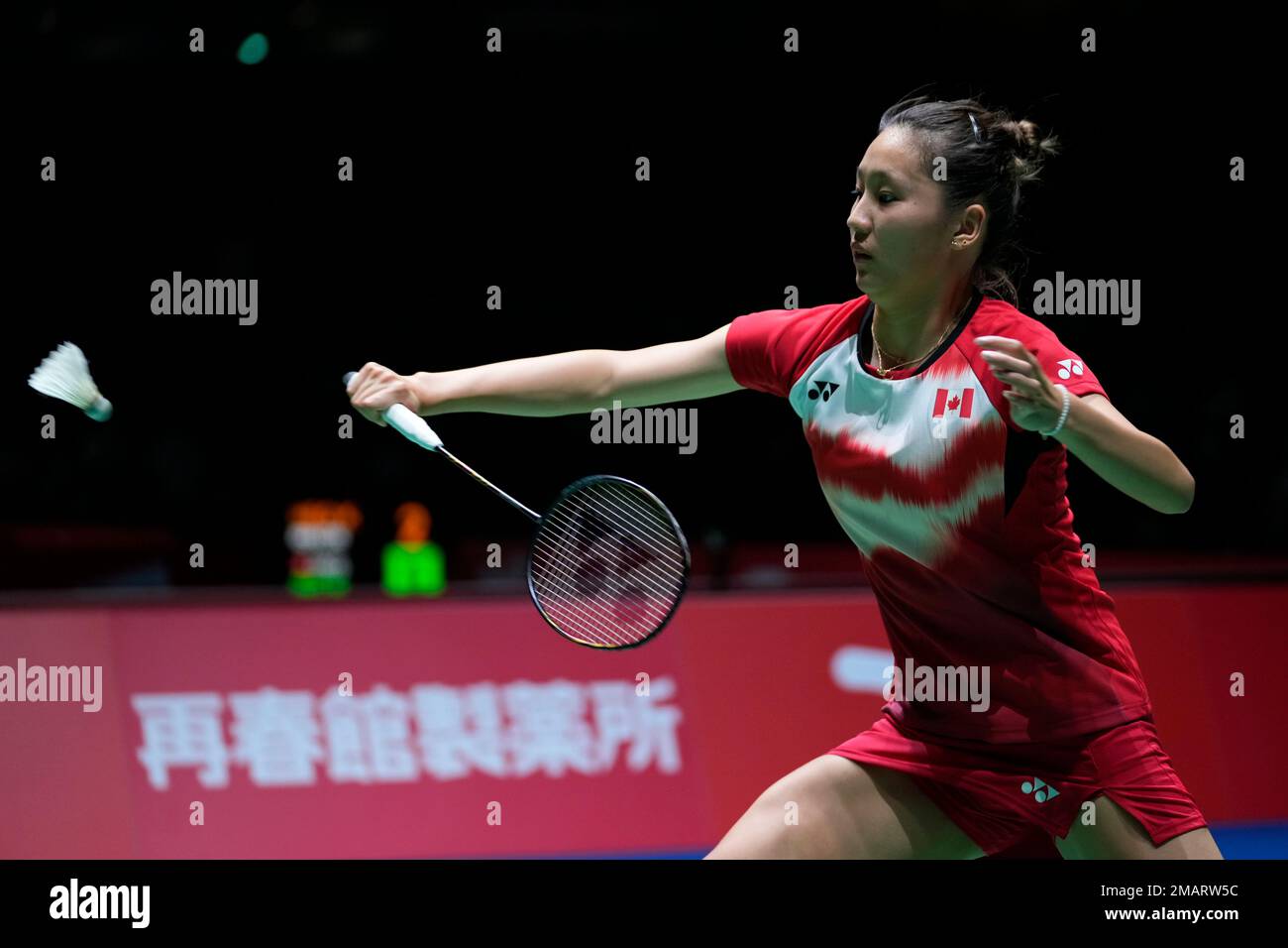 Wen Yu Zhang of Canada plays a return against Thet Htar Thuzar of Myanmar during a badminton ...