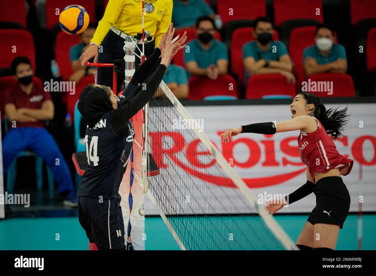 South Korea's Hosun Choi spikes the ball against Iran players during ...