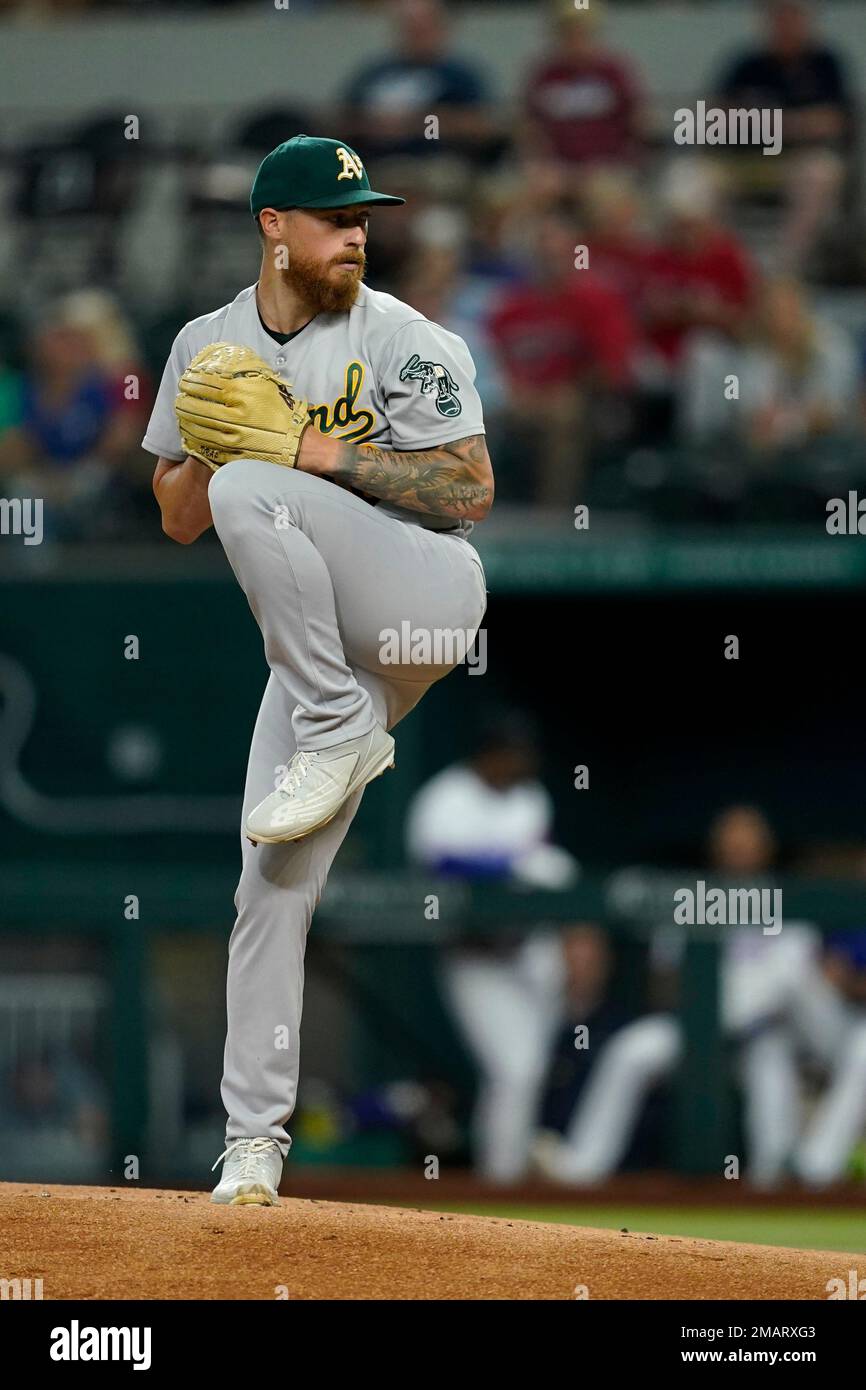 Oakland Athletics starting pitcher Adam Oller winds up to deliver the ...