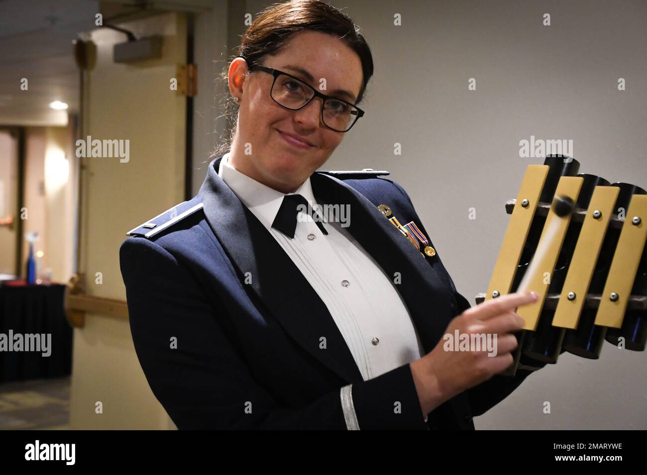 Lt. Elizabeth Carter of the 168th Wing chimes the bells to begin the ...