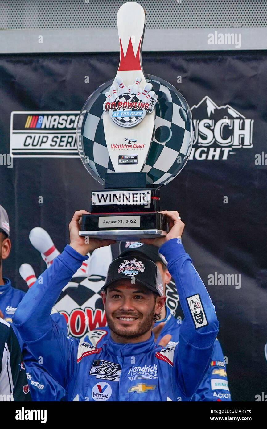 Kyle Larson holds up a trophy after winning a NASCAR Cup Series auto race in Watkins Glen, N.Y ...