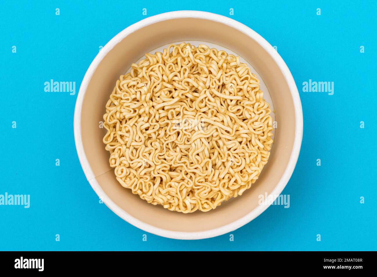 Opened Package with Uncooked Instant Noodles on Blue Background. Raw ...