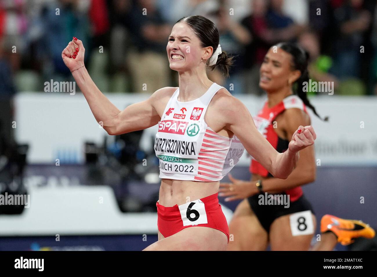 Pia Skrzyszowska, of Poland, crosses the finish line ahead of third placed Ditaji Kambundli, of ...