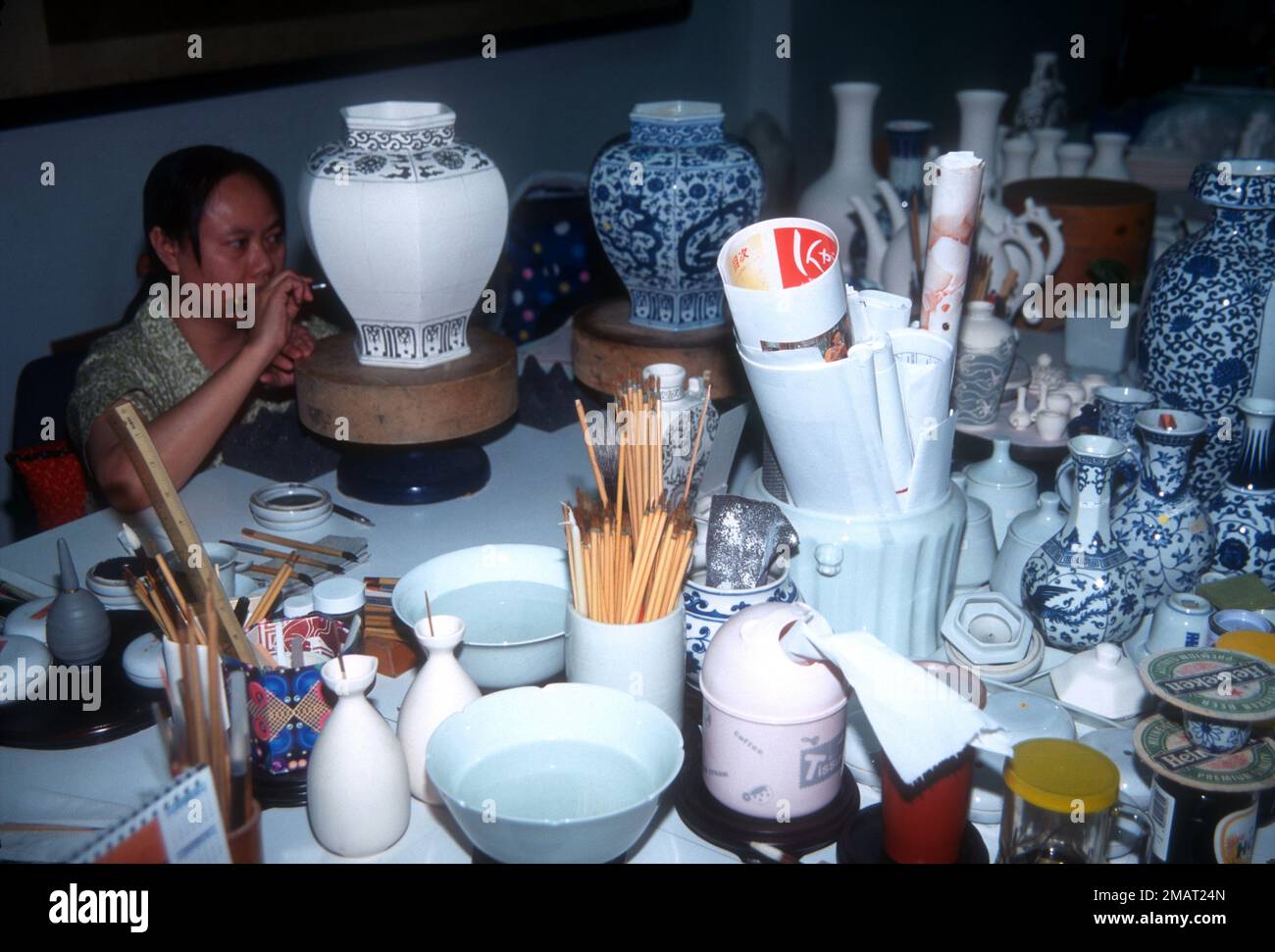 Crafts factory with woman hand-painting ceramic vase, Singapore Stock ...