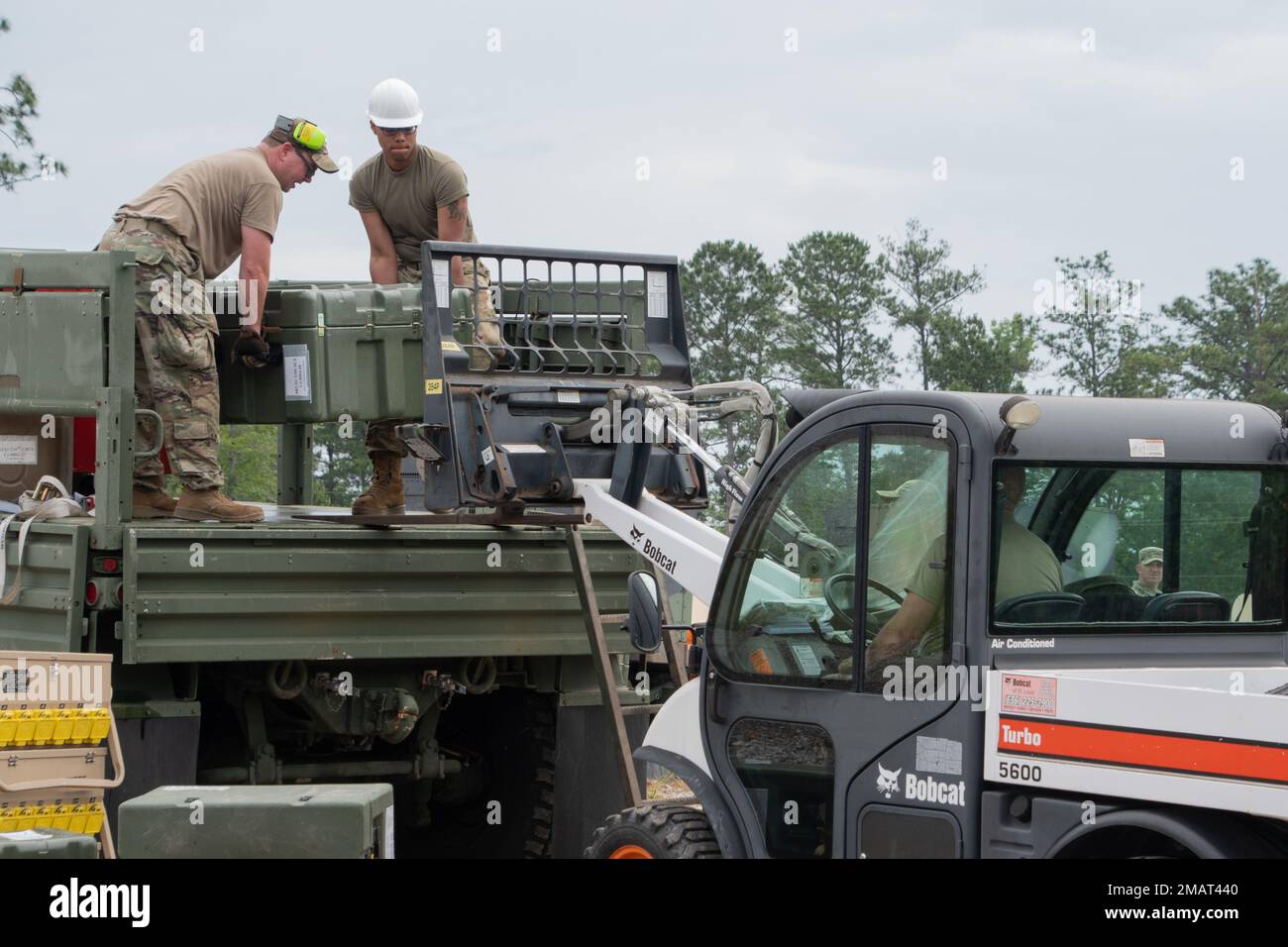 Members of the 239th Combat Communications Squadron offload items from ...