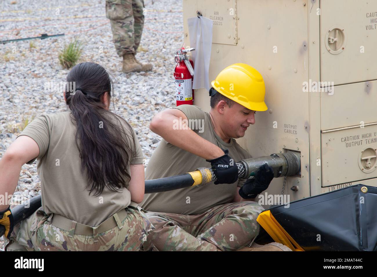 Members of the 147th Combat Communications Squadron attach power to a ...