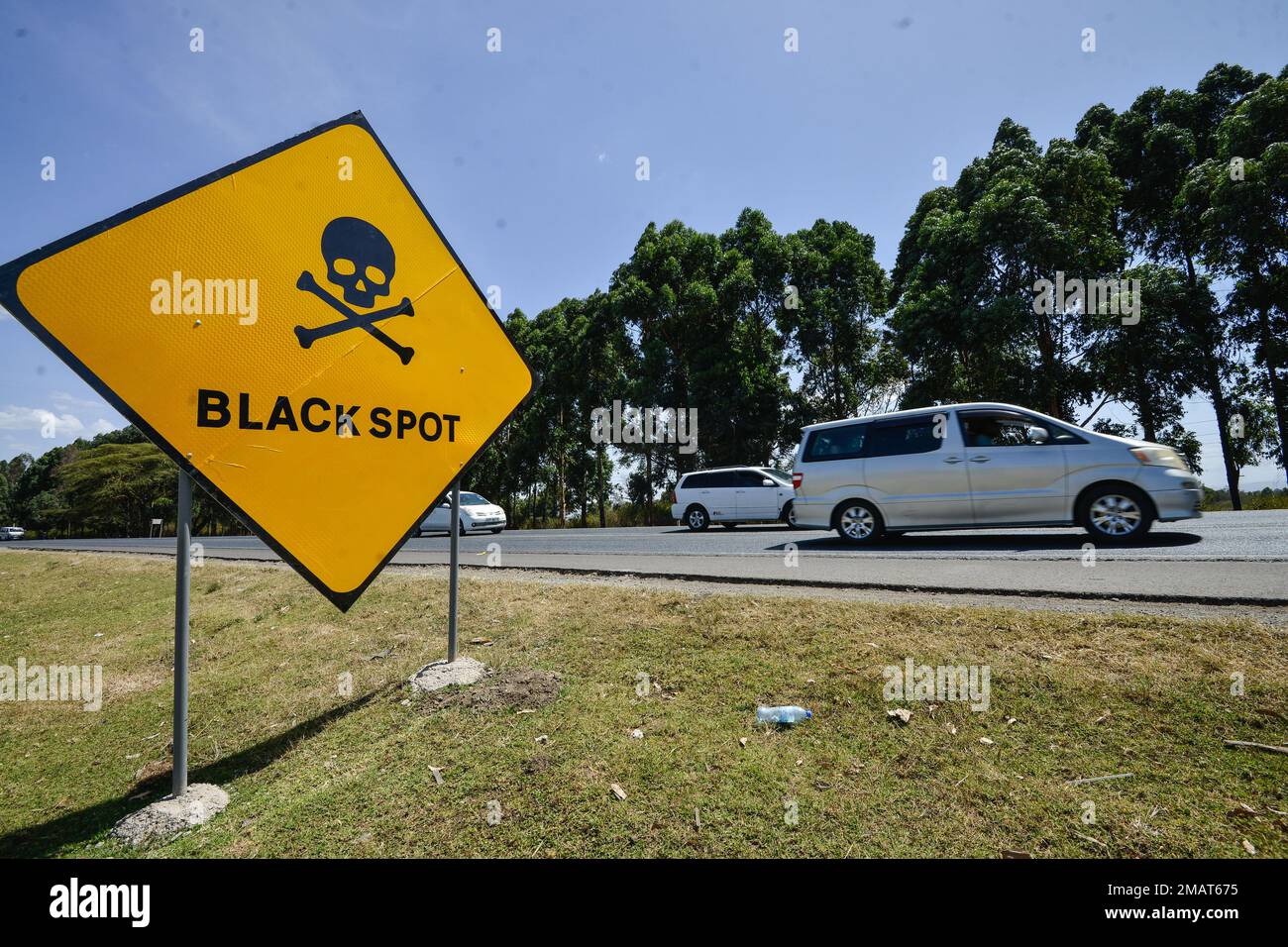 Vehicles drive past a road sign warning motorists of a black spot 5km ...
