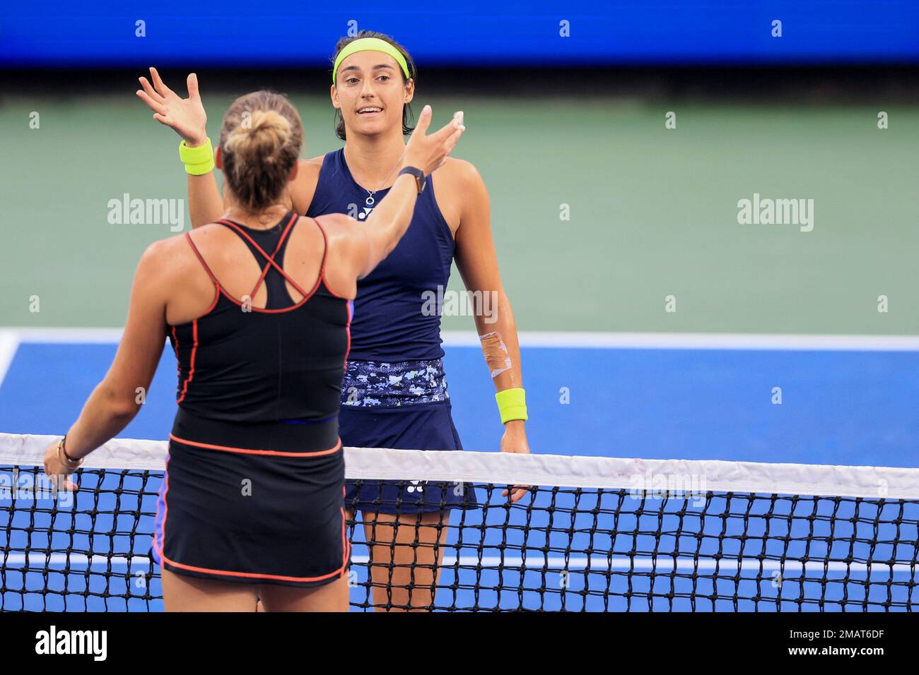 Caroline Garcia, back, of France, shakes hands with Aryna Sabalenka, of ...