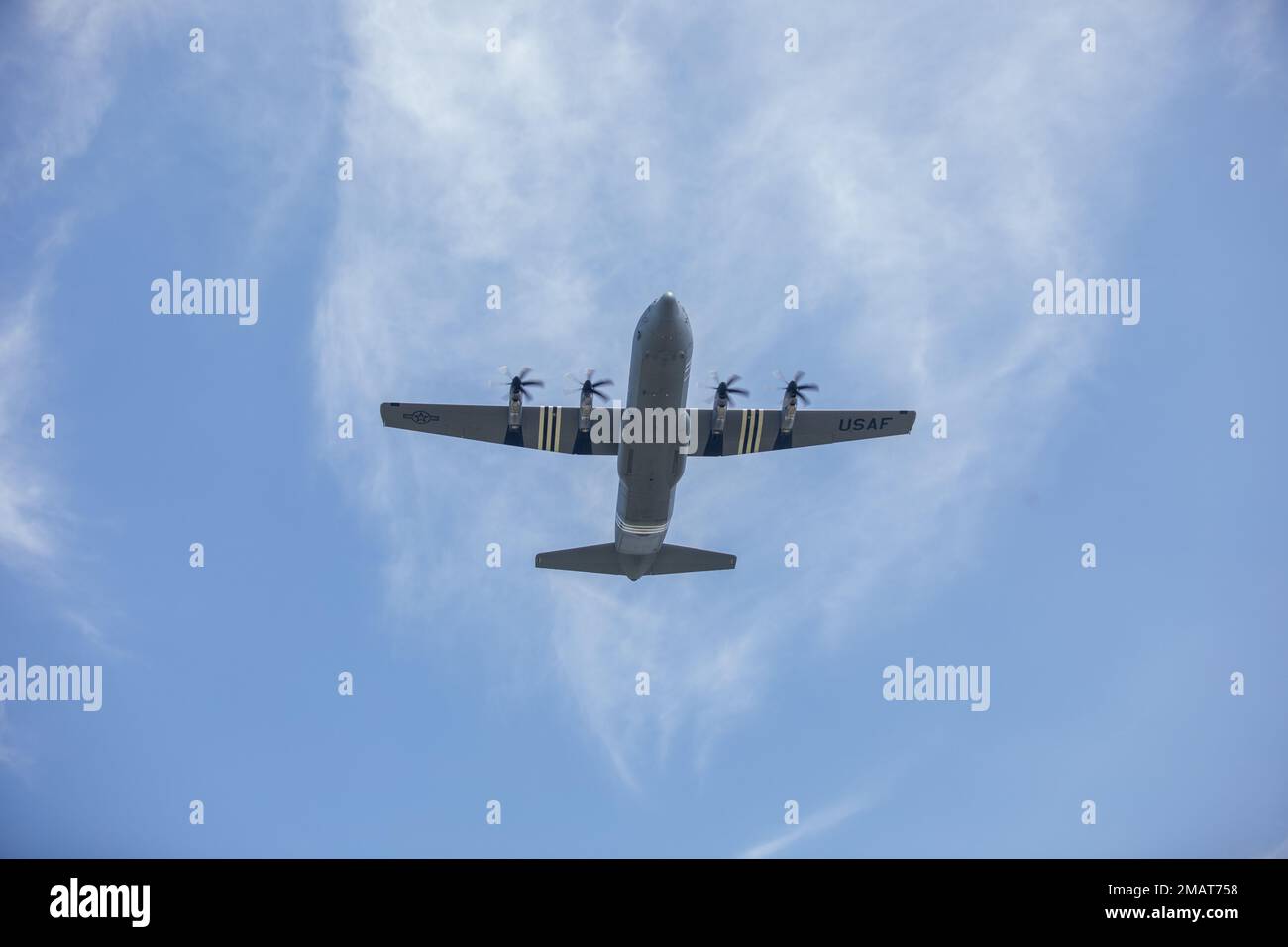 A U.S. Air Force C-130J Super Hercules Aircraft flies over the town of ...
