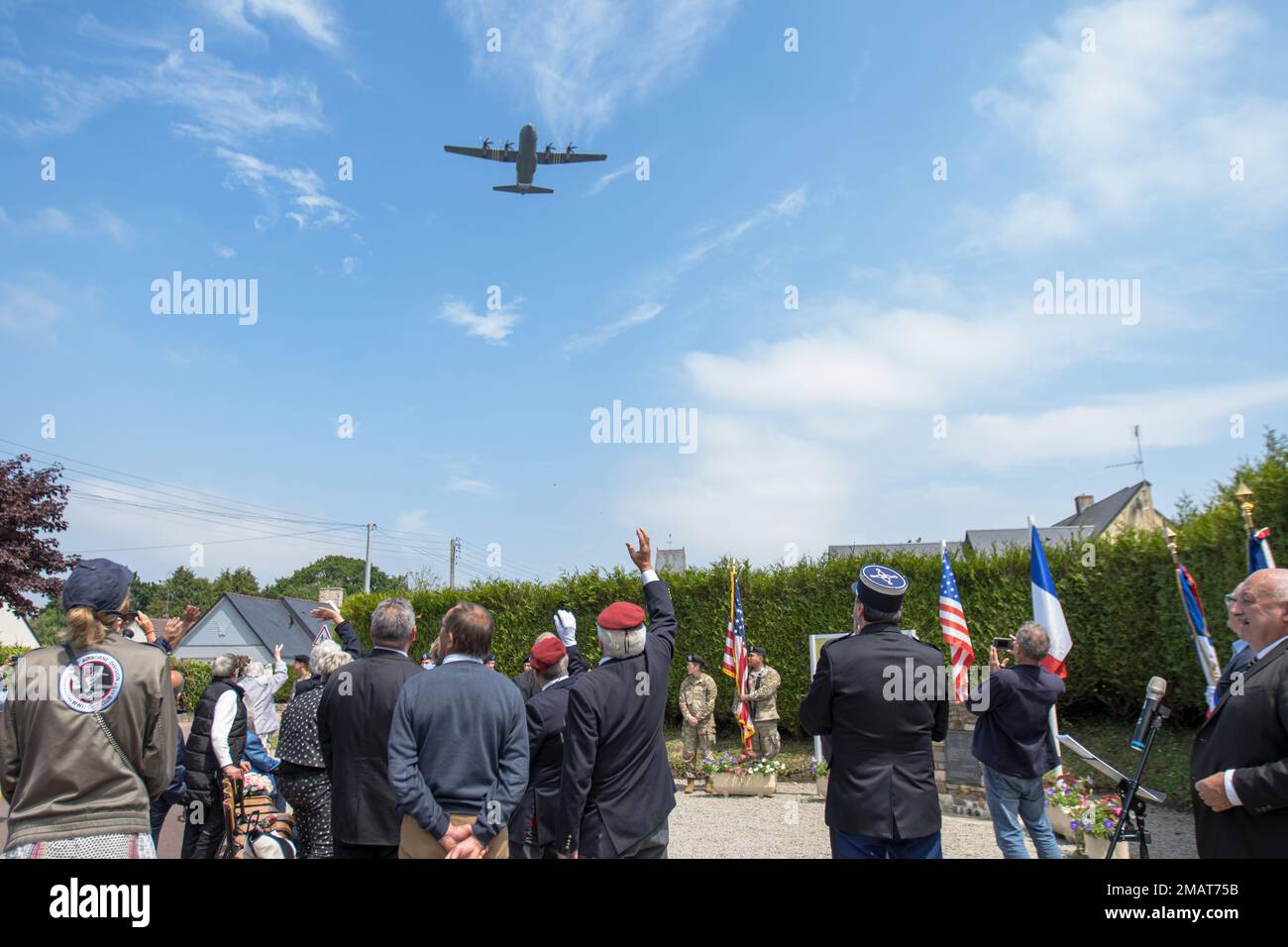 A U.S. Air Force C-130J Super Hercules aircraft flies over the town of ...