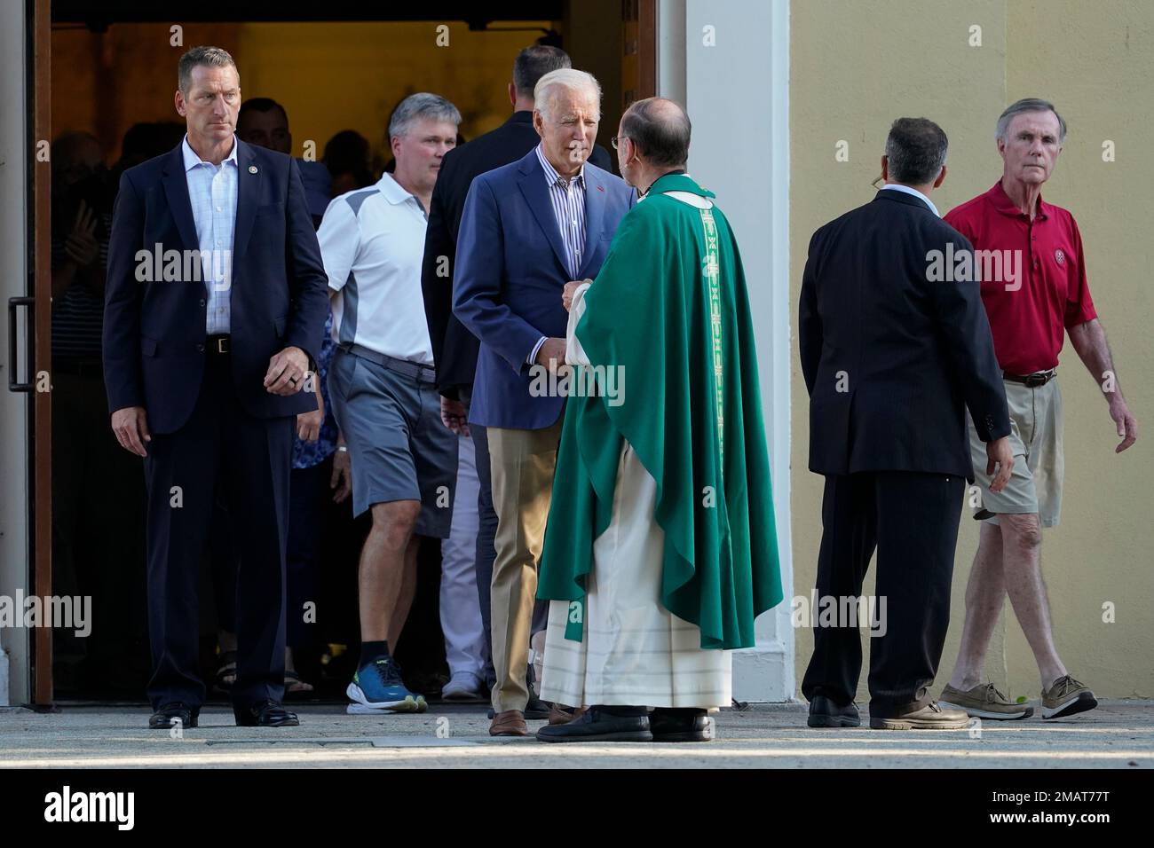 President Joe Biden speaks with a priest after attending Mass at St ...