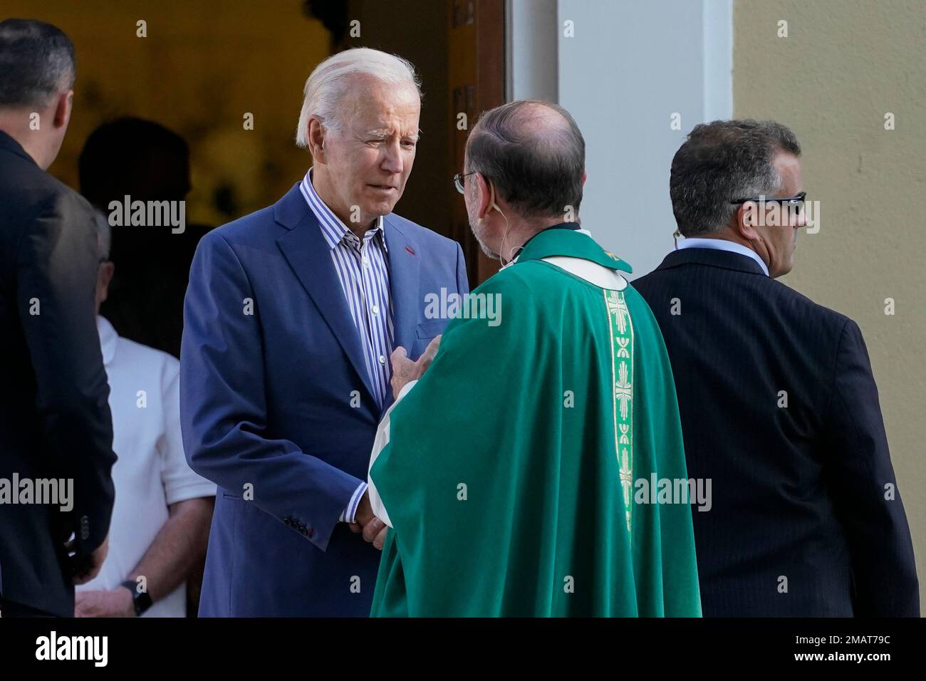 President Joe Biden speaks with a priest after attending Mass at St ...