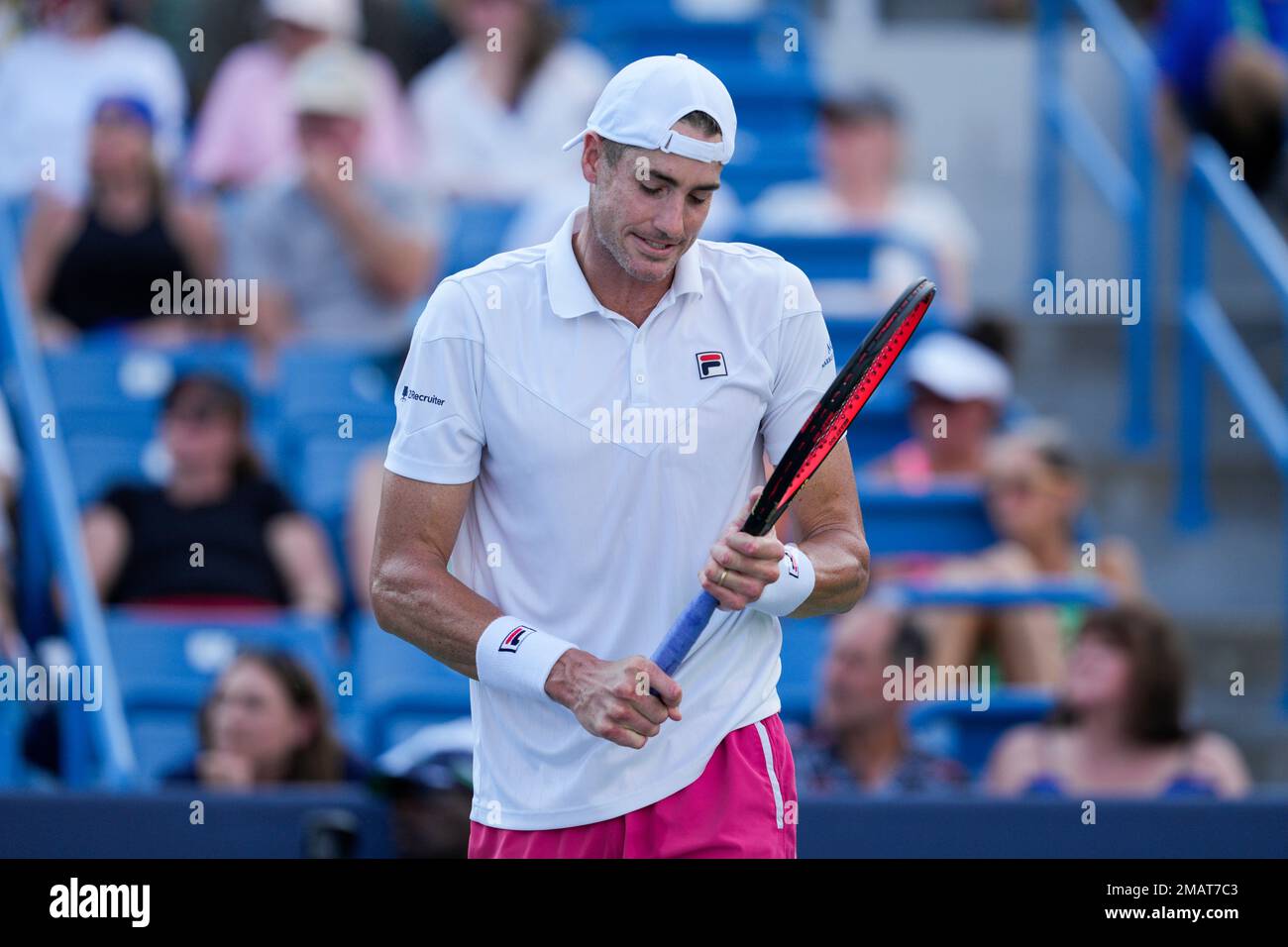 John Isner, of the United States, plays during the Western & Southern ...