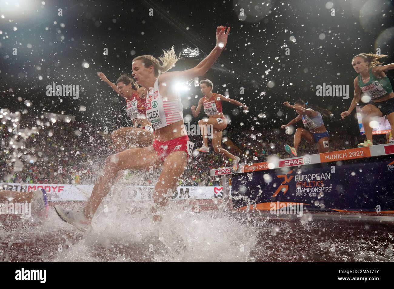 Athletes compete in the Women's 3000 meters steeplechase during the ...