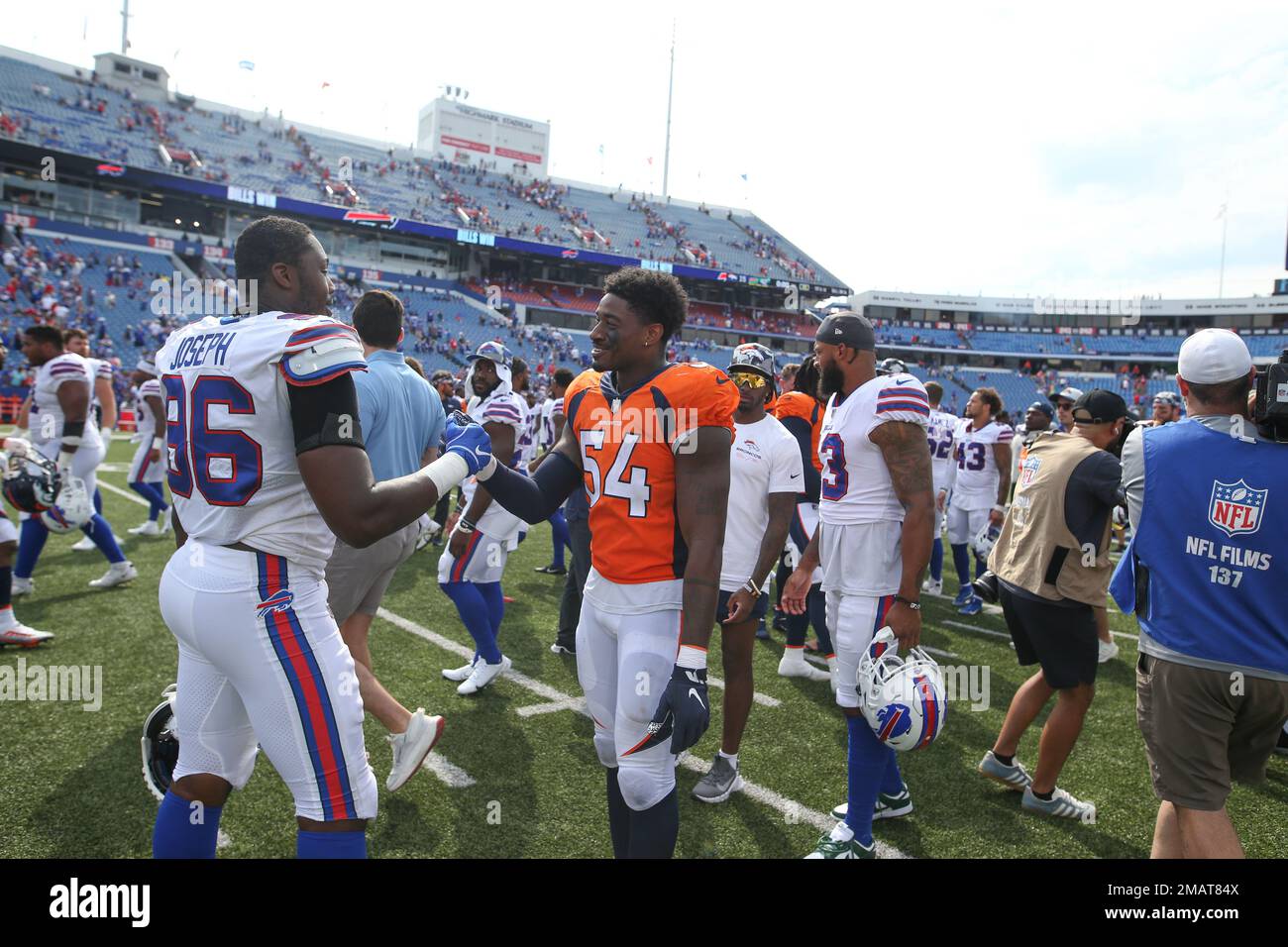 Denver Broncos' Barrington Wade (54), center, leaves the field after a ...