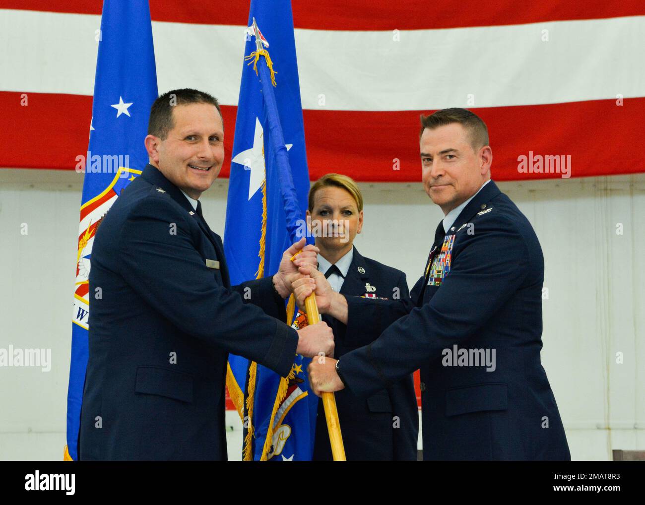 Col. Shawn E. Holtz (right), former 110th Wing commander, passes the ...