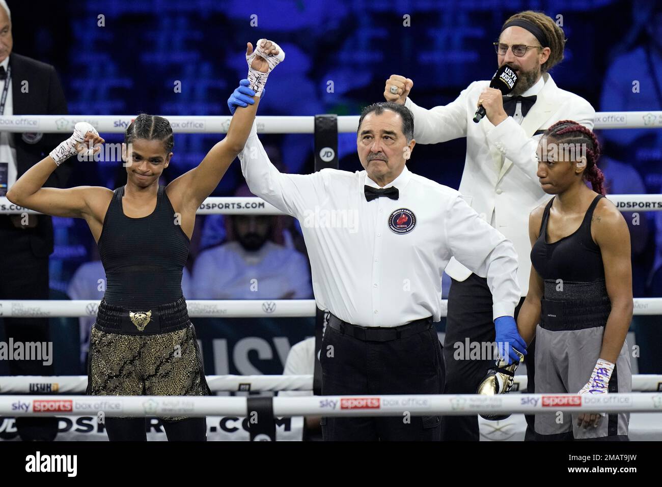 Ramla Ali, left, has her hand raised as she celebrates after beating ...