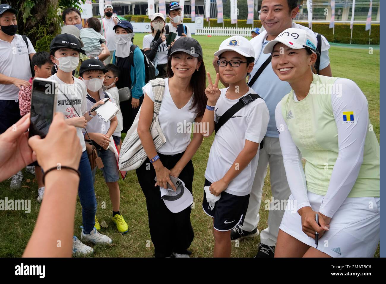 Japan's Hinako Shibuno, right, poses for a photograph with fans during Simone Asia Pacific Cup ...