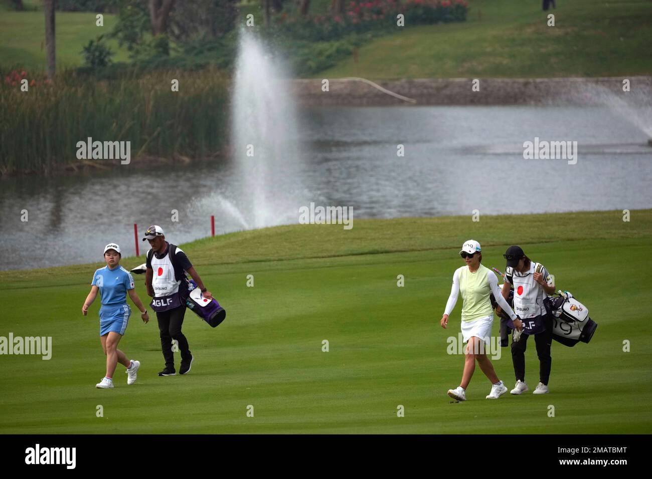 Japan's Hinako Shibuno, right, walks on the ninth fairway with her sister Kiriko during Simone ...