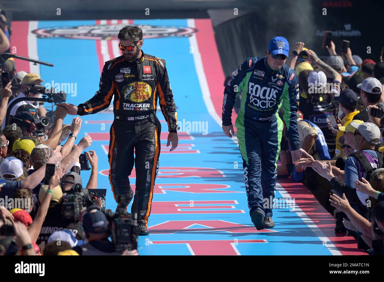 Martin Truex Jr., left, and Erik Jones walk on the stage during driver ...