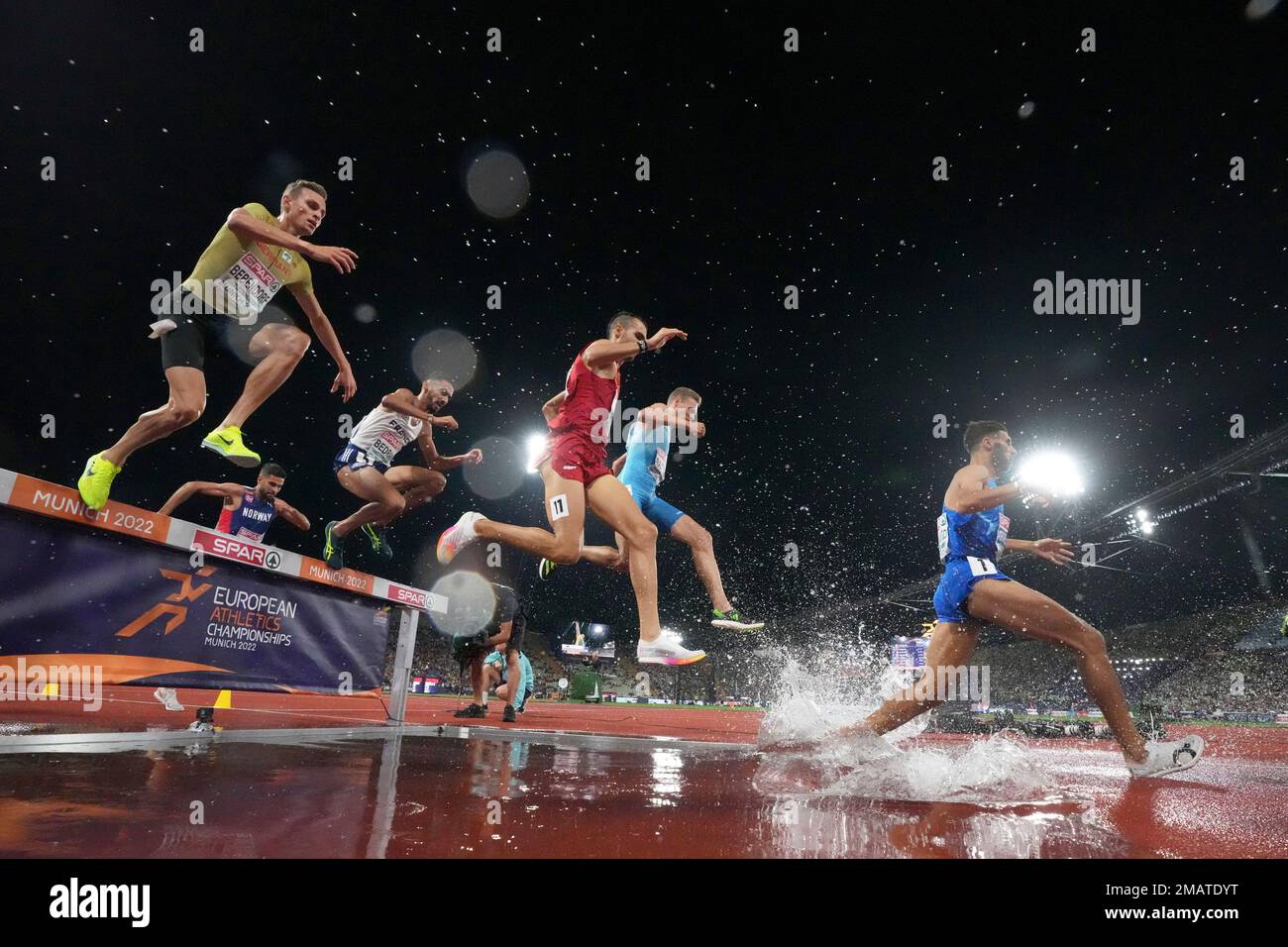 Athletes compete in the Men's 3000 meters steeplechase during the ...