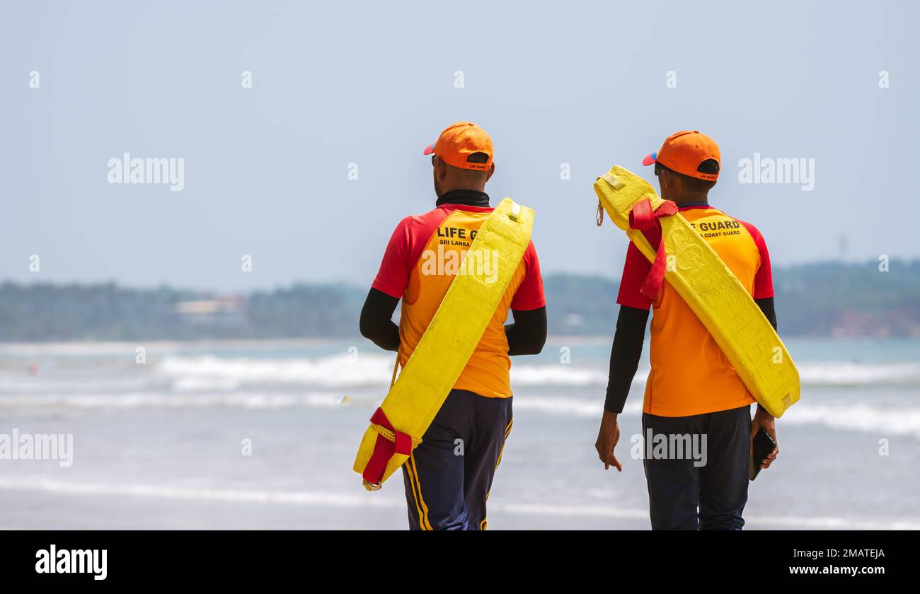 Two Lifeguards on duty at the tropical beach, Both carrying rescue ...
