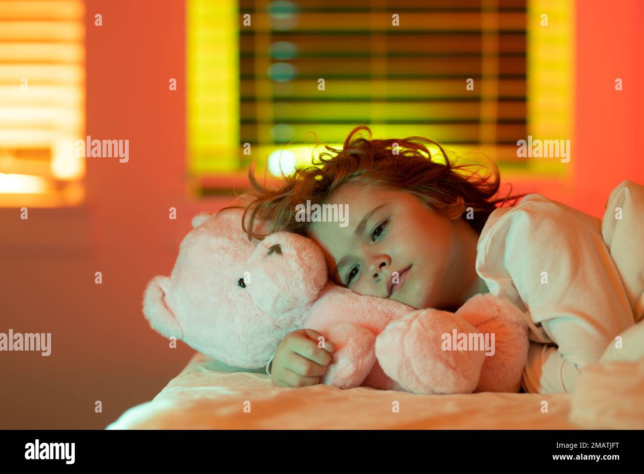 Cute drowsy sleepy child with toy teddy bear in bed, bedtime, childhood ...