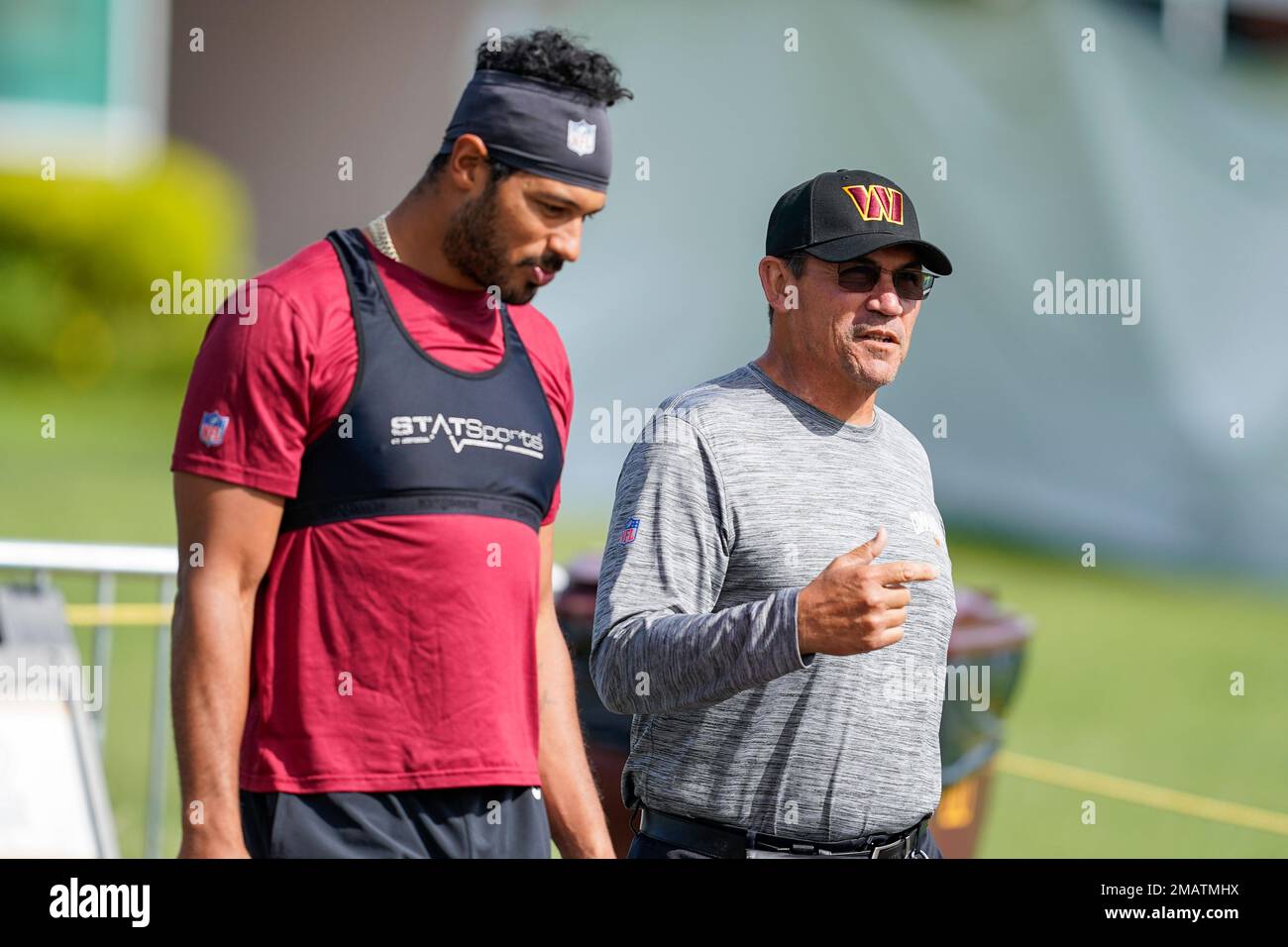 Washington Commanders tight end Logan Thomas, left, and head coach Ron ...