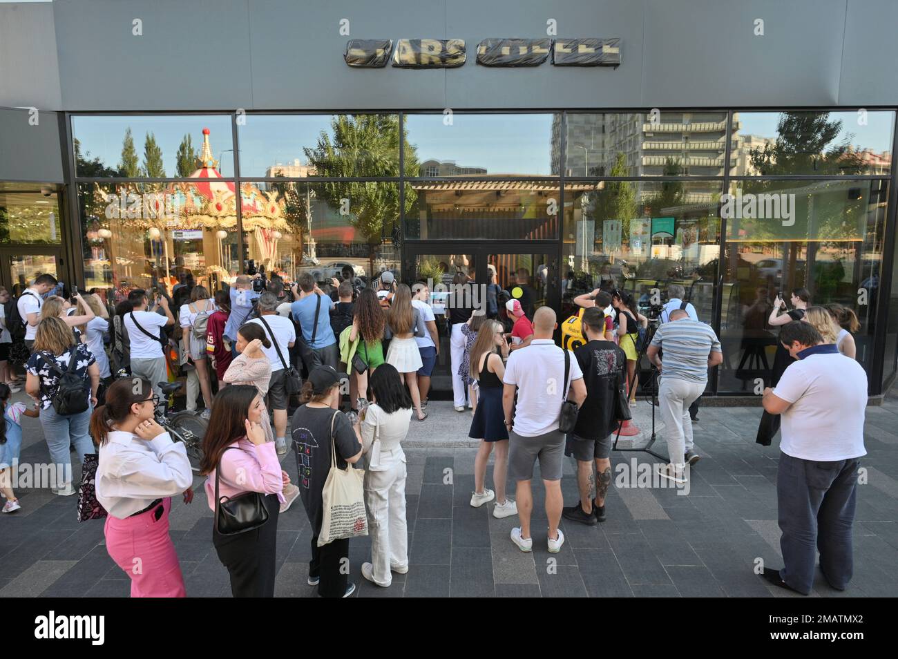 People gather to visit a newly opened Stars Coffee coffee shop in the ...