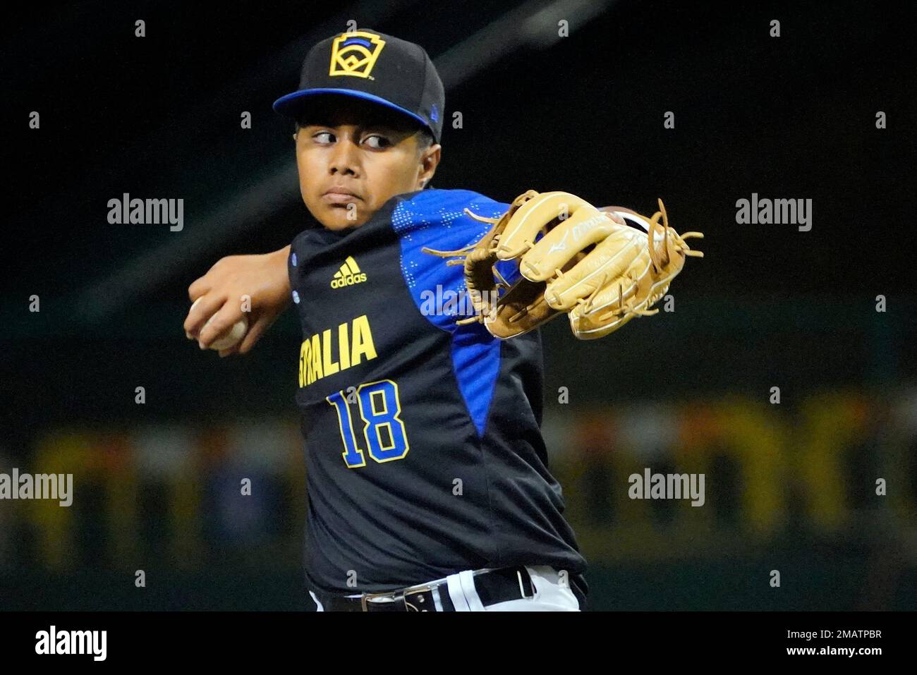 Australia's Logan Lokeni (18) delivers a pitch against Canada during ...