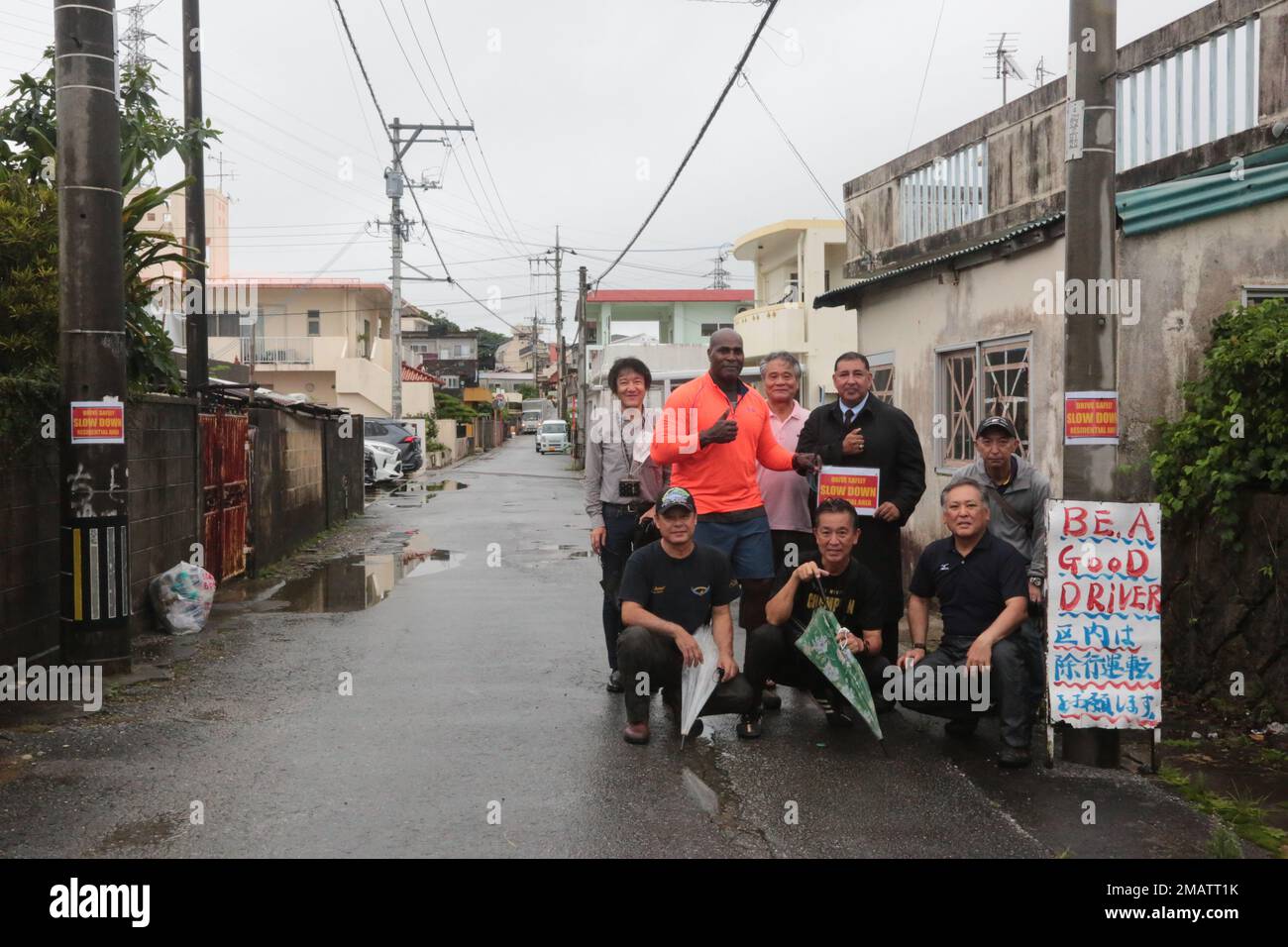 Everyone, including neighboring residents, poses for a post-work photo ...