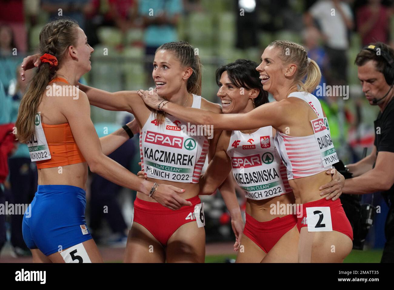 Femke Bol, of the Netherlands, left, is congratulated by the Polish ...
