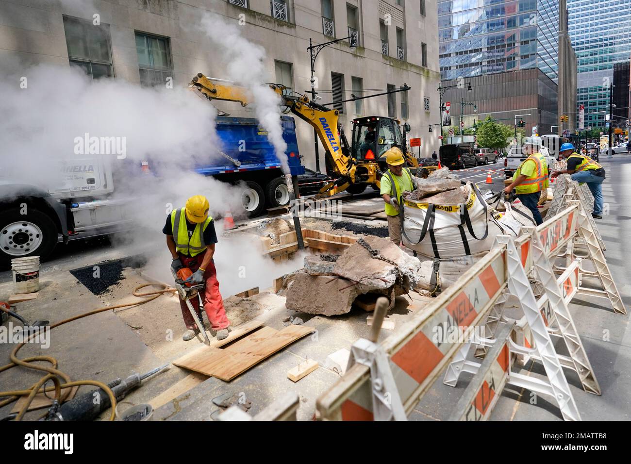 A construction crew works on fixing a ruptured steam pipe in lower ...