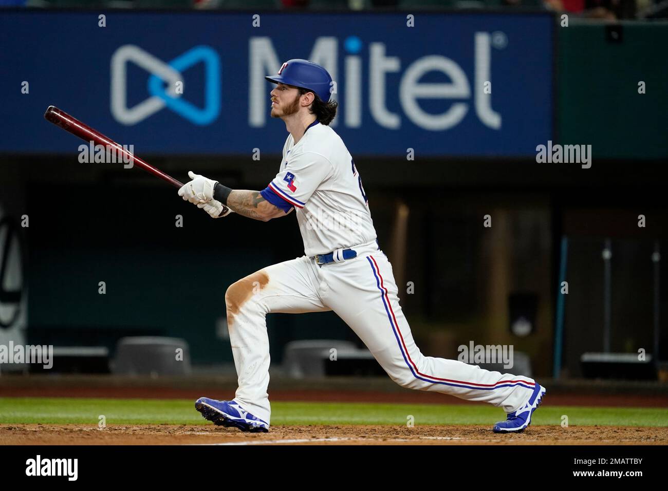 Texas Rangers' Jonah Heim follows through on a swing during a baseball ...