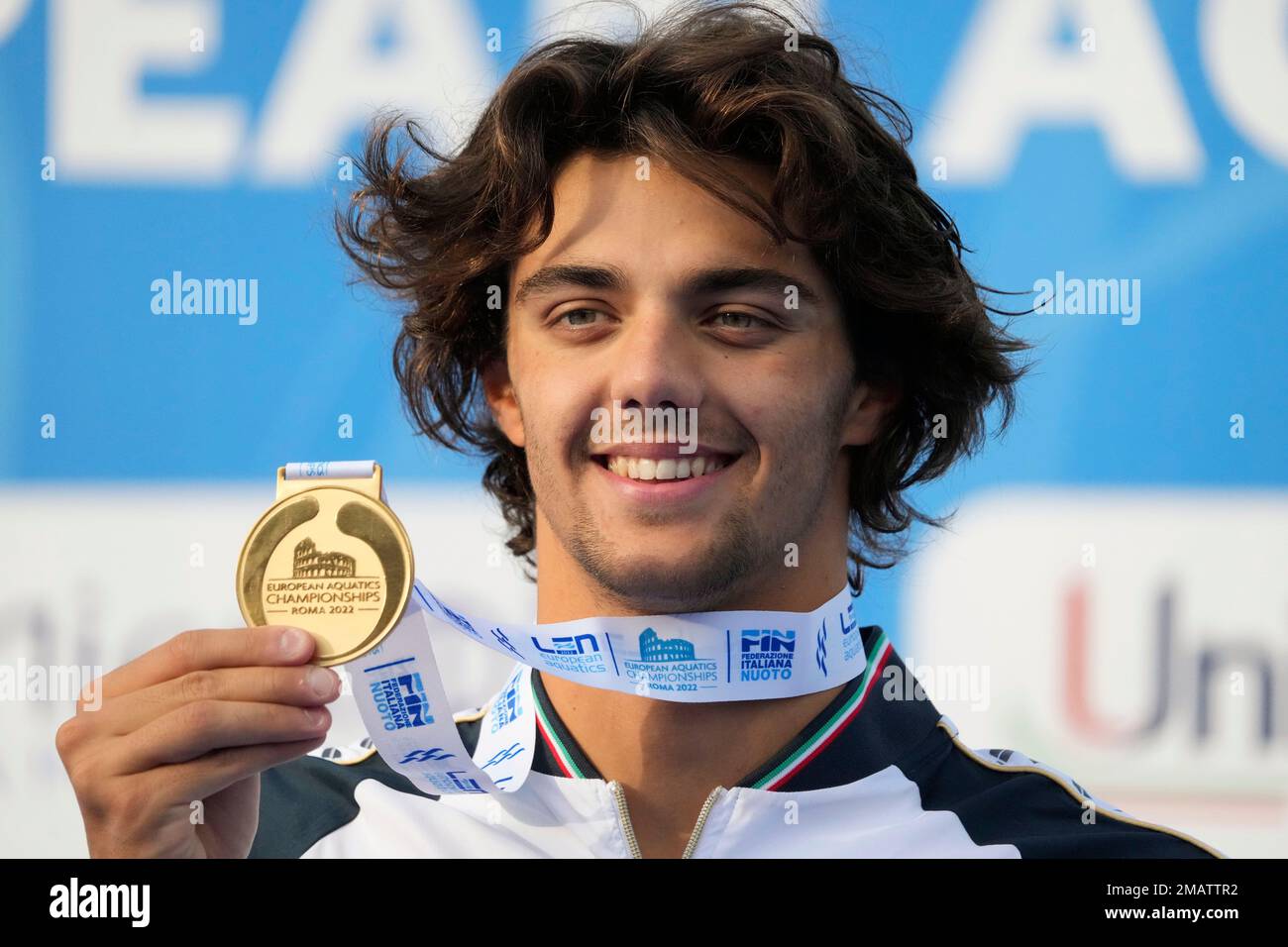 Thomas Ceccon of Italy holds his gold medal on the podium of the Men's ...