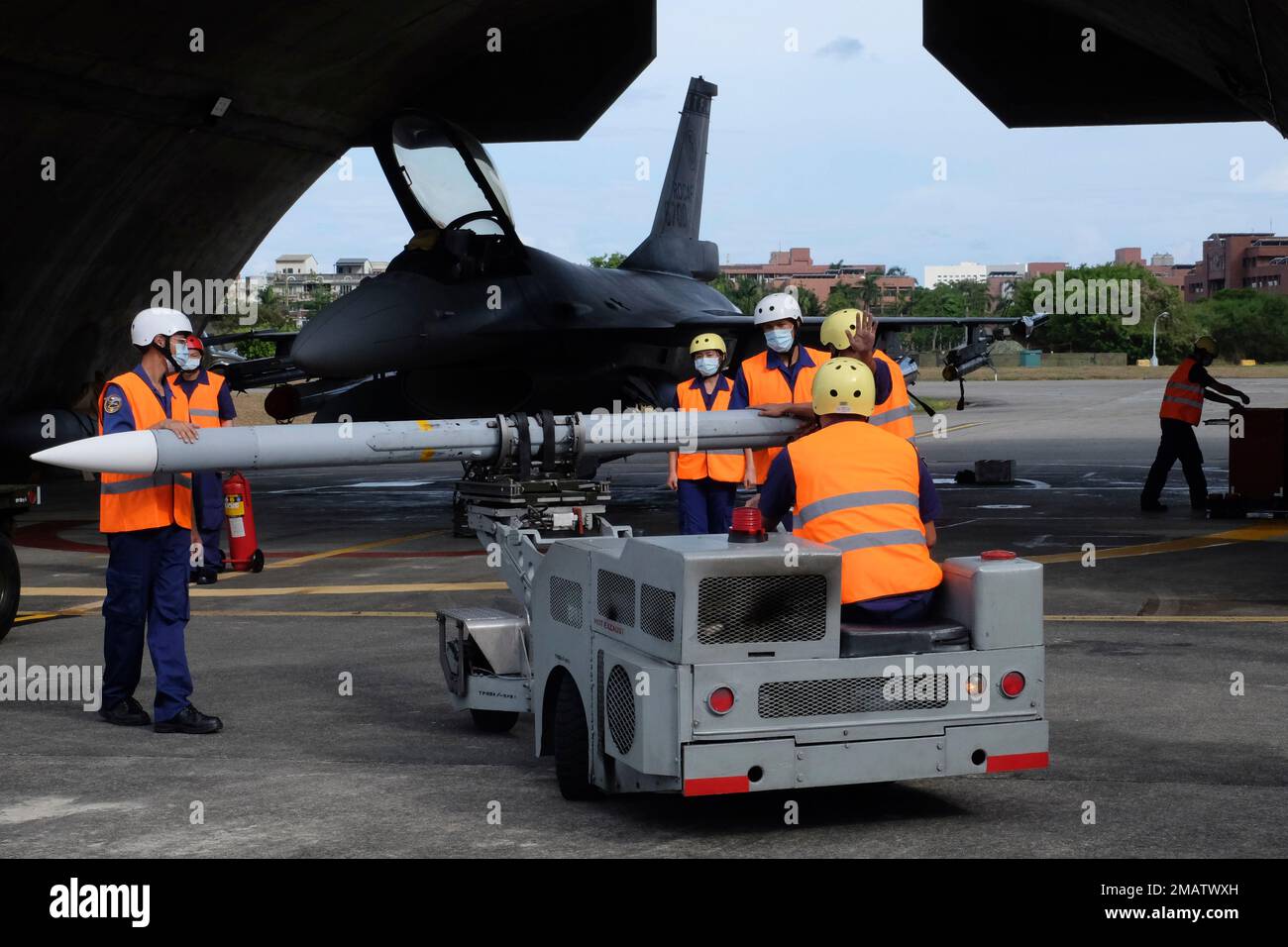 Military personnel prepare to load a AIM-120 advanced medium range air ...