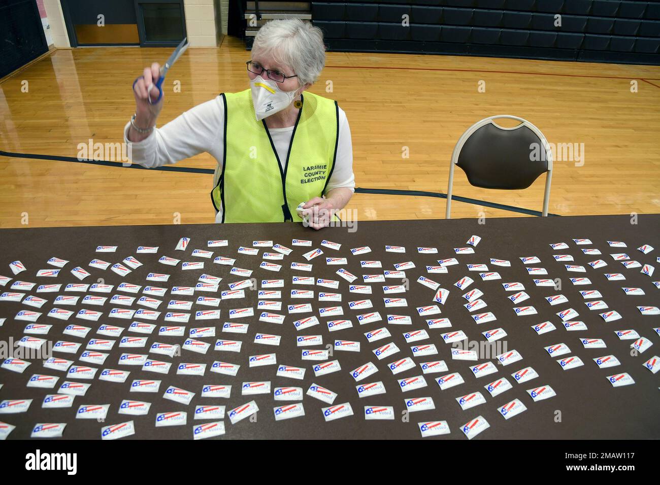 Election judge Marion Yoder hands out "I Voted" stickers at a polling ...