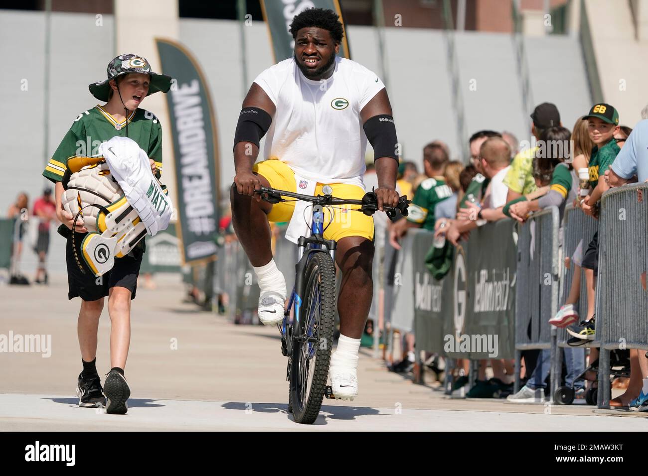 Green Bay Packers' Devonte Wyatt rides a bike to an NFL football joint ...