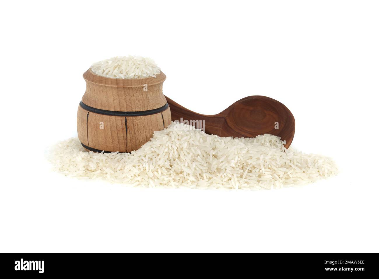 Uncooked long-grain rice in small wooden barrel and wooden spoon ...