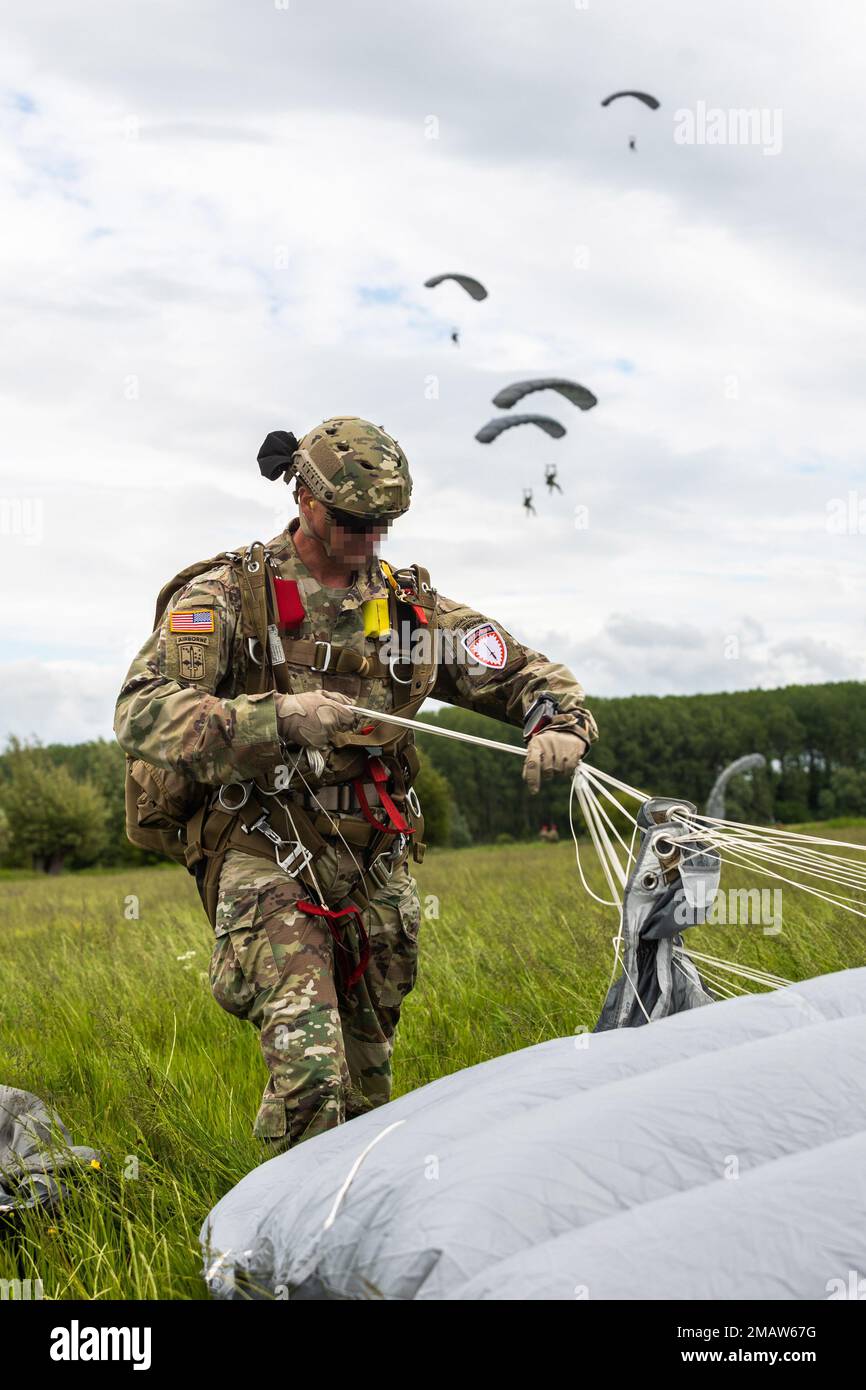 U.S. Army 1-10 Special Forces Group soldiers parachute to a drop zone during a High Altitude Low ...
