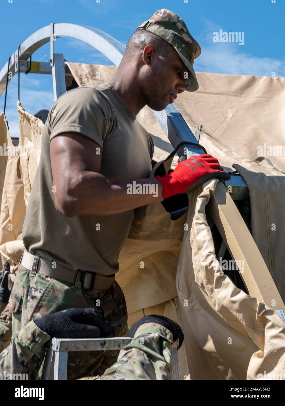 An Airmen with the 914th Aeromedical Staging Squadron constructs a tent ...