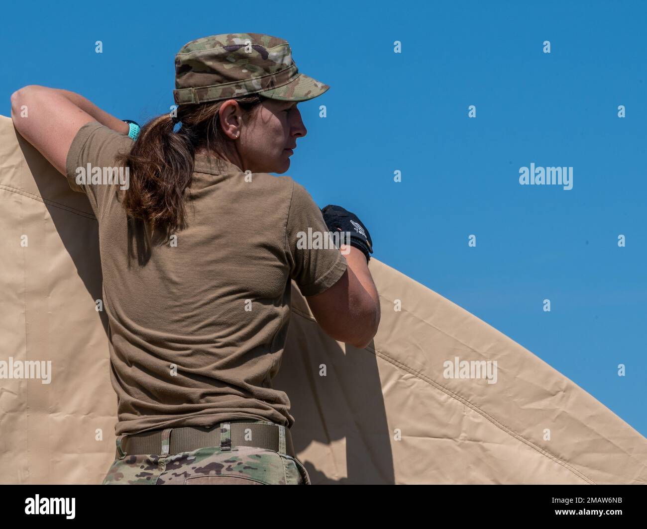 An Airmen with the 914th Aeromedical Staging Squadron constructs a tent ...