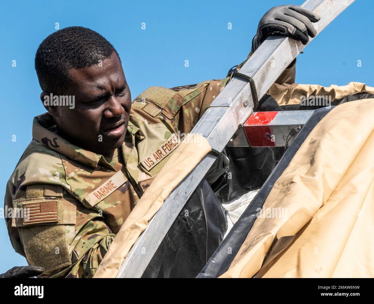An Airmen with the 914th Aeromedical Staging Squadron constructs a tent ...