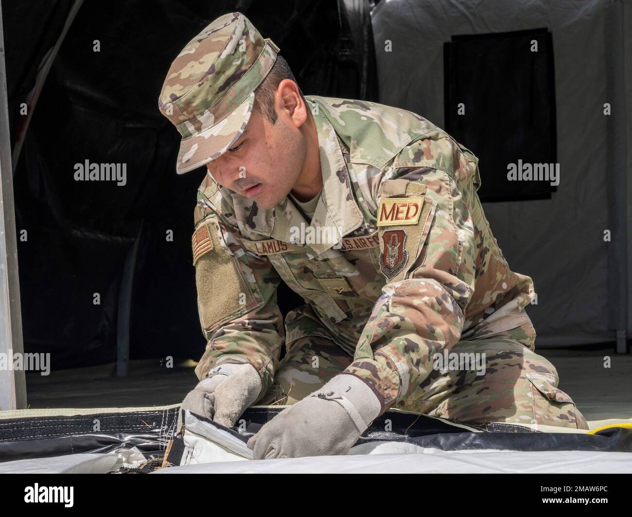 An Airman with the 914th Aeromedical Staging Squadron constructs a tent ...
