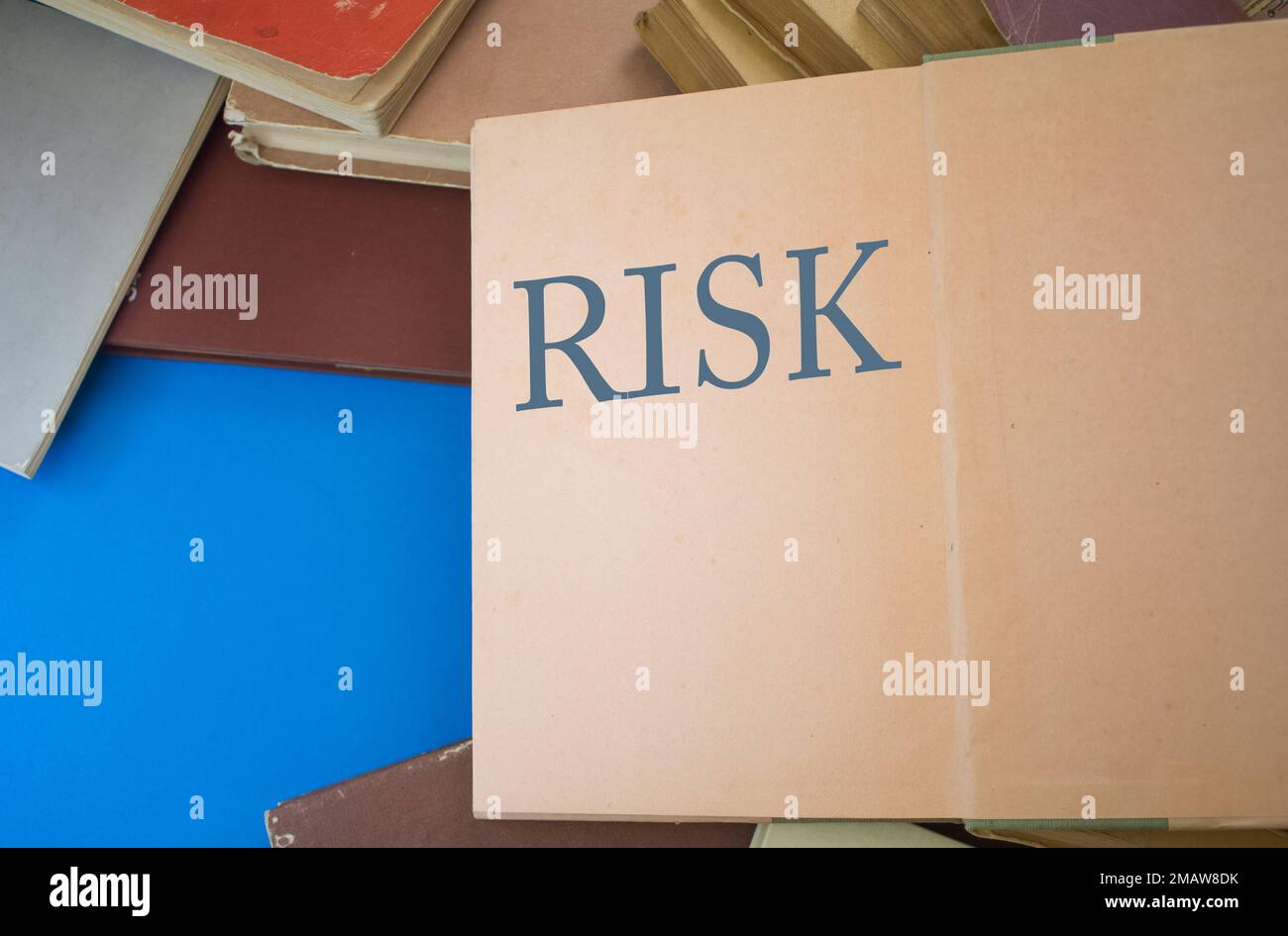 Risk word in opened book with vintage, natural patterns old antique ...