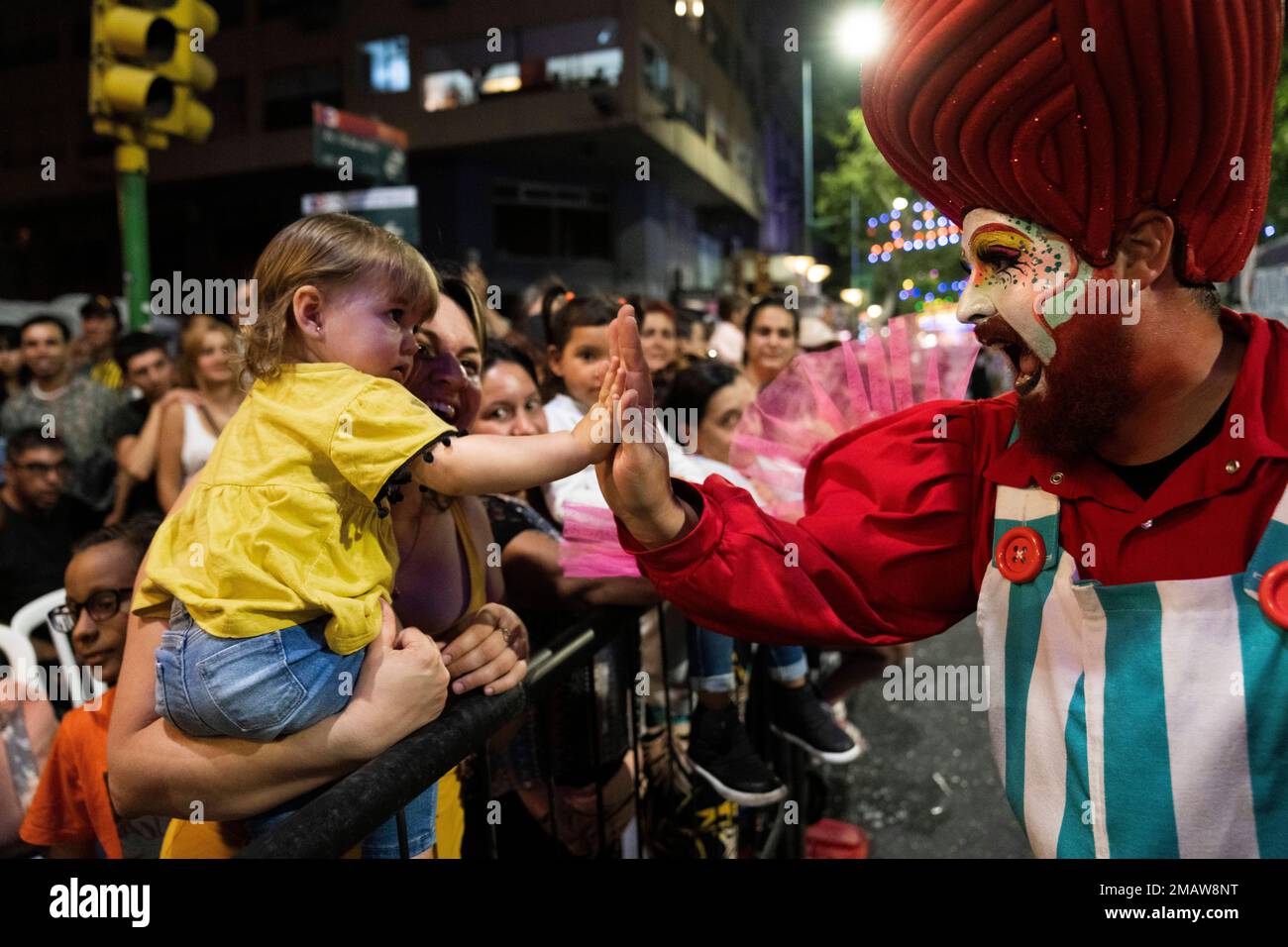 A "murga" singer chats with a child during the inaugural carnival ...