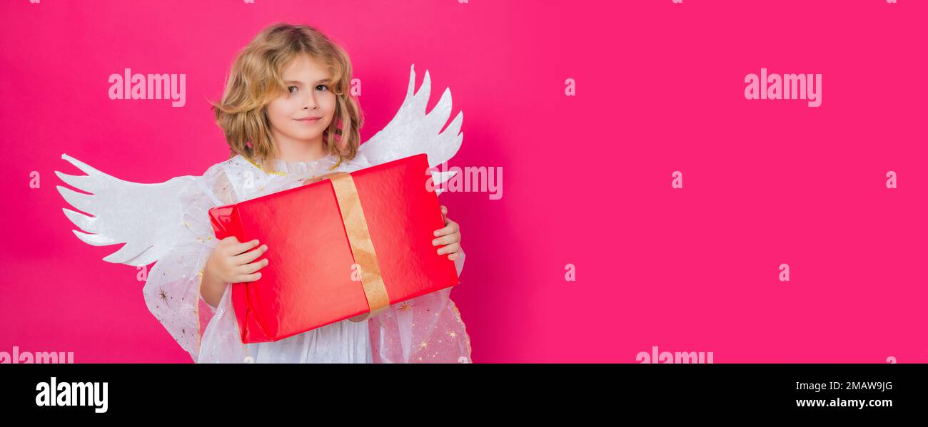 Kid boy angel with gift box present. Little cute child at angel costume ...