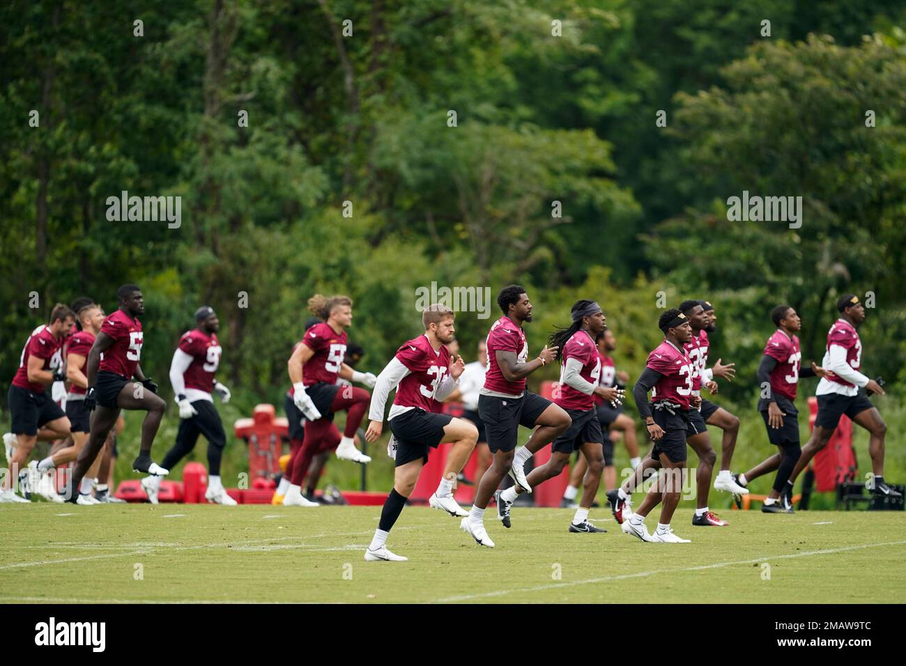 The Washington Commanders warm up during practice at the team's NFL ...