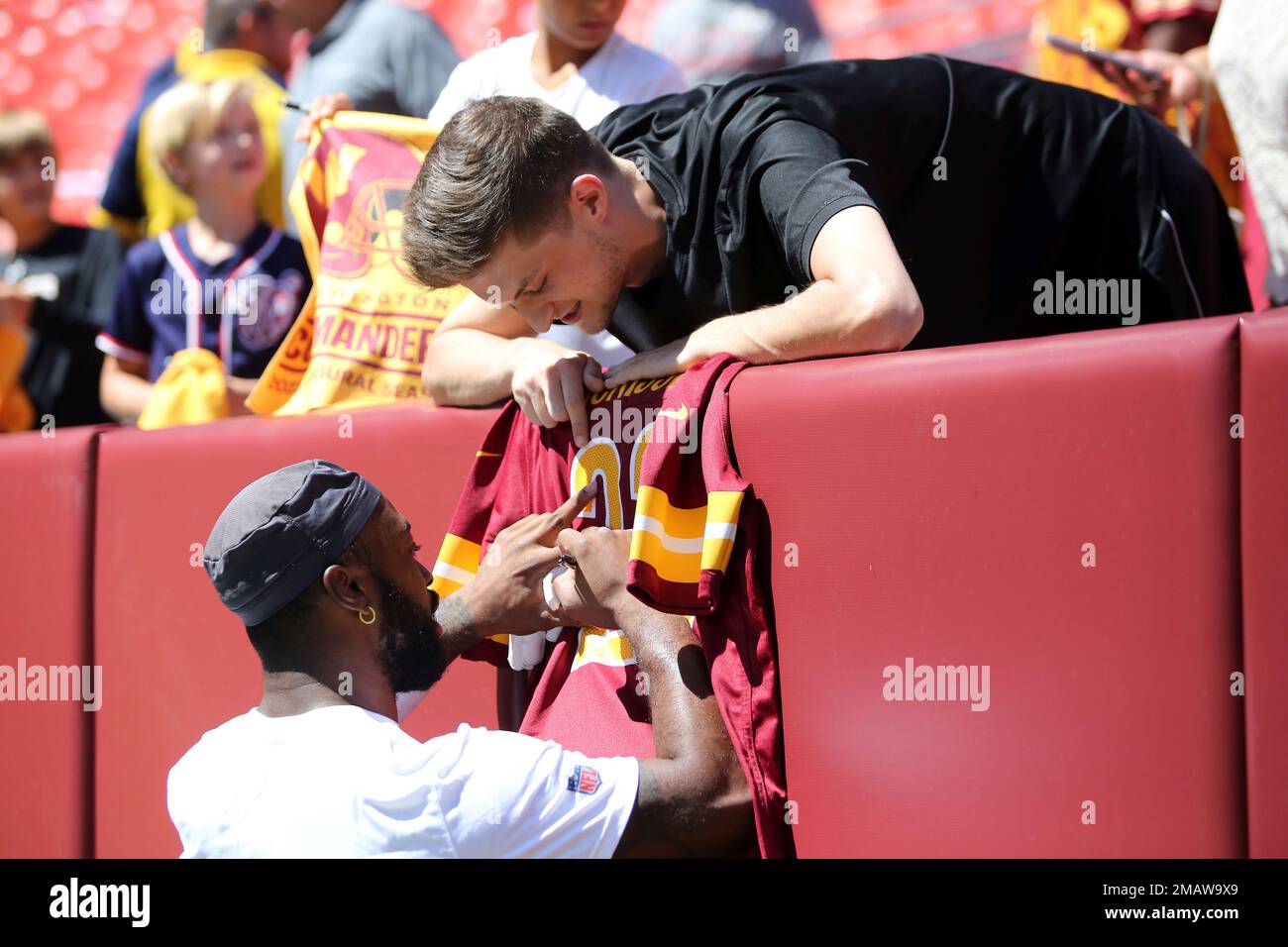 Washington Commanders running back J.D. McKissic (23) signs a jersey ...