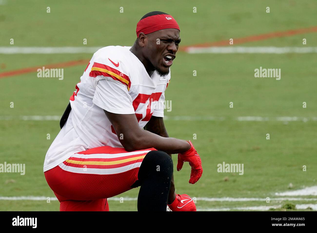 Kansas City Chiefs defensive end Frank Clark talks to teammates during ...